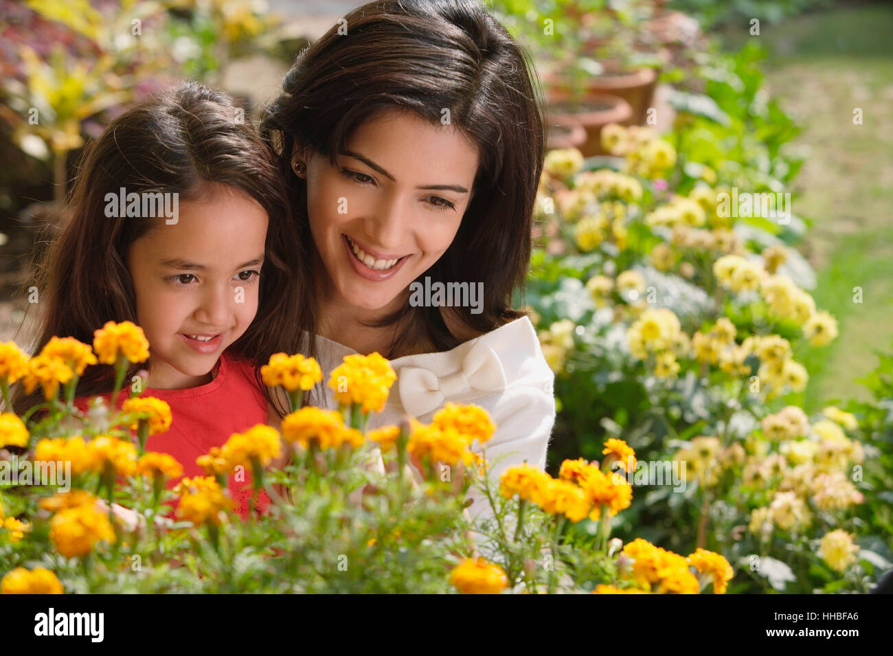 mother and daughter look at flowers Stock Photo - Alamy