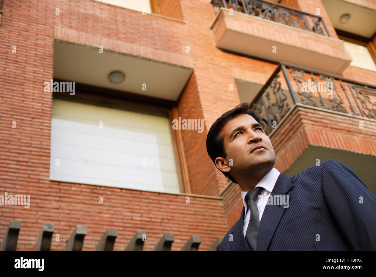 man in suit, standing in front of home Stock Photo - Alamy
