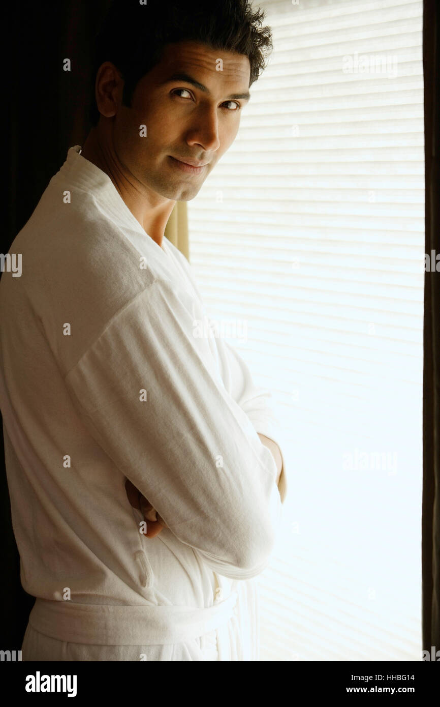 man in robe, standing near window Stock Photo - Alamy