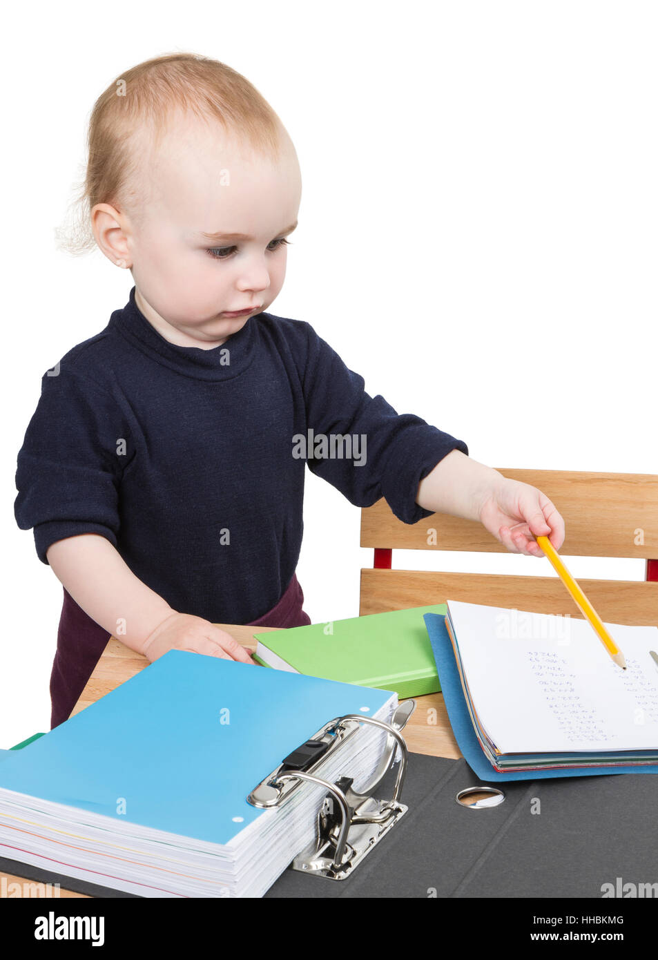 young child working at writing desk in light background Stock Photo - Alamy