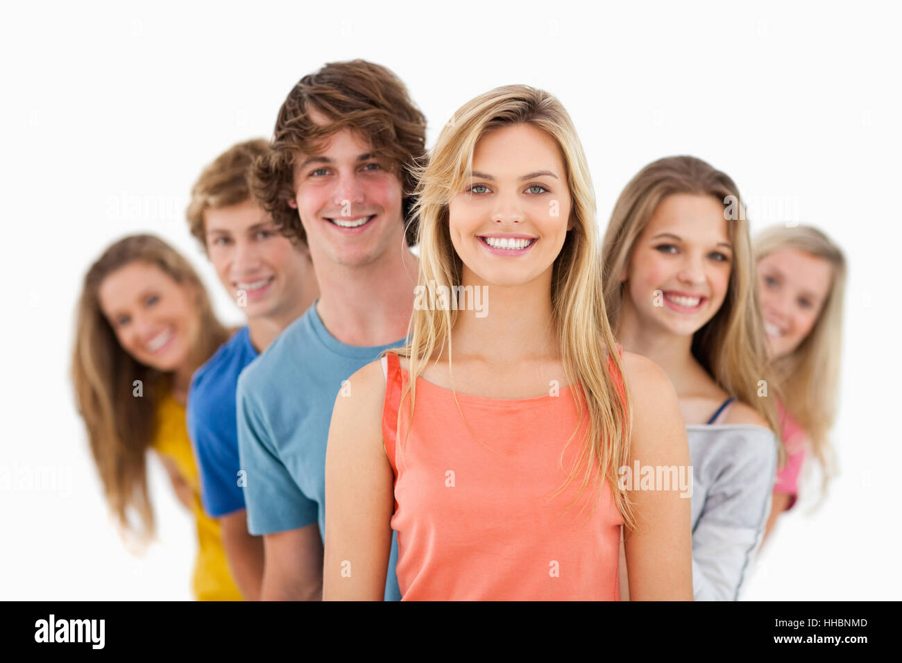 A smiling group standing behind one another at varied angles Stock ...