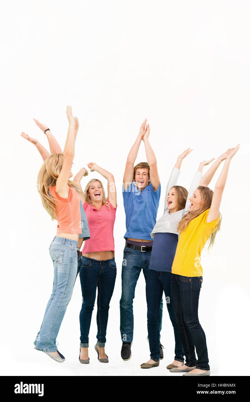 A group of friends cheering as they jump in the air and look at one ...
