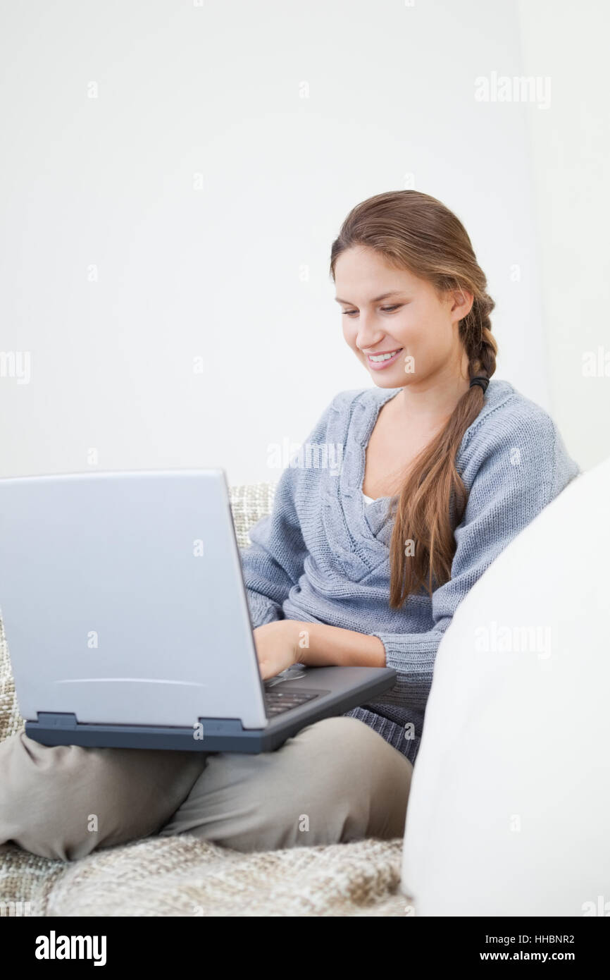 Women sitting while using a laptop in a sitting room Stock Photo - Alamy
