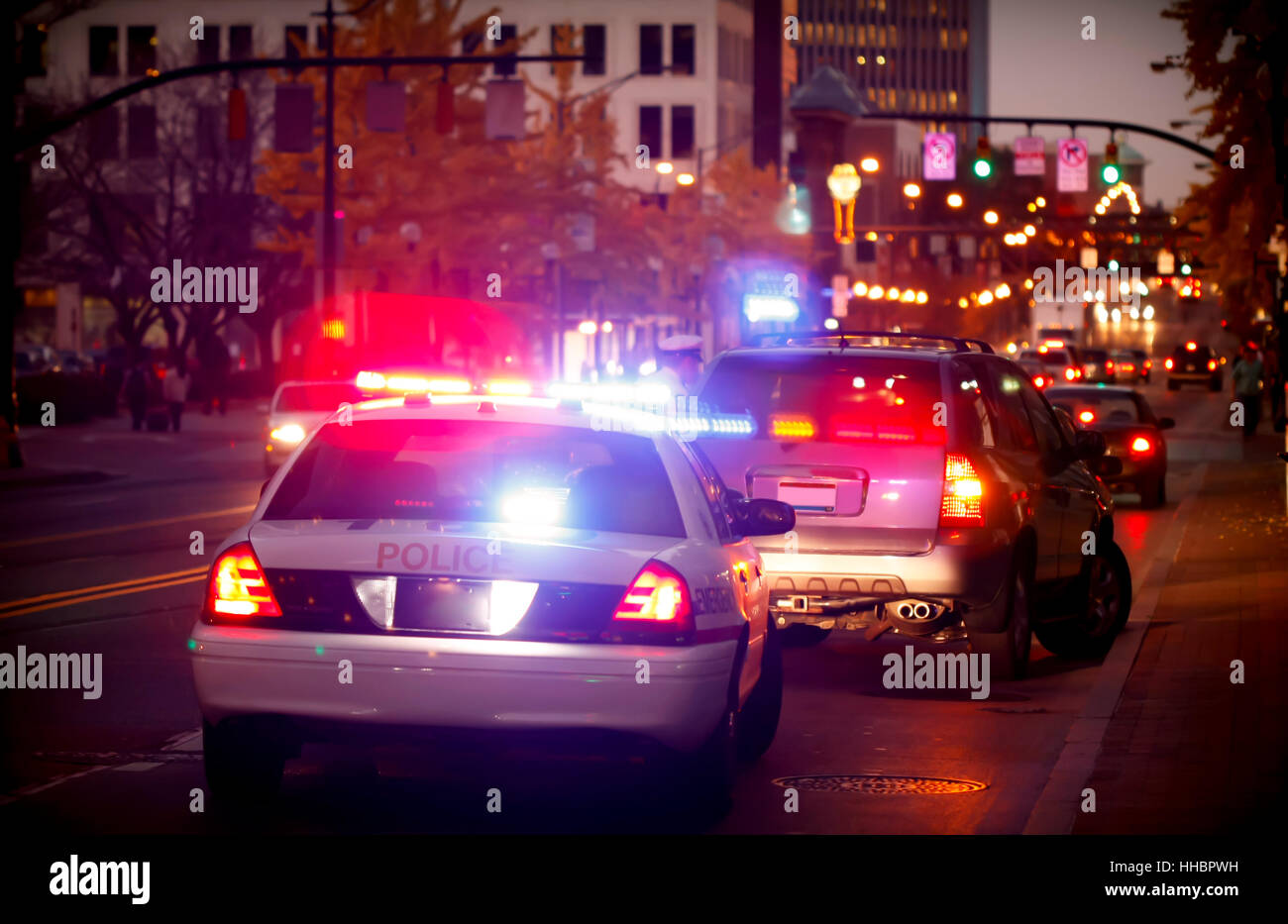A police officer pulls over a driver for a traffic violation in a ...