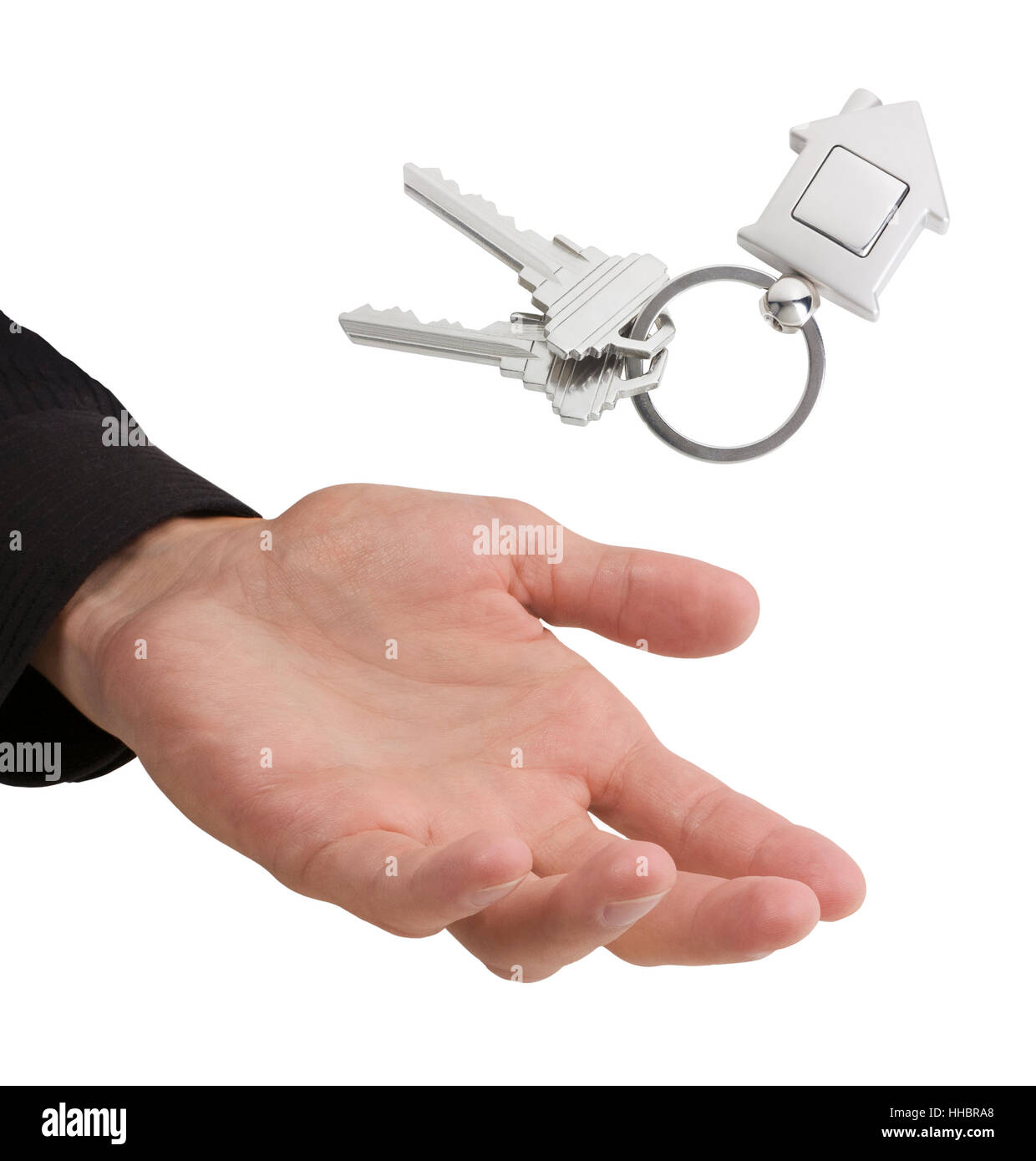 Hand catching or tossing keys with house-shaped fob, with space for ...