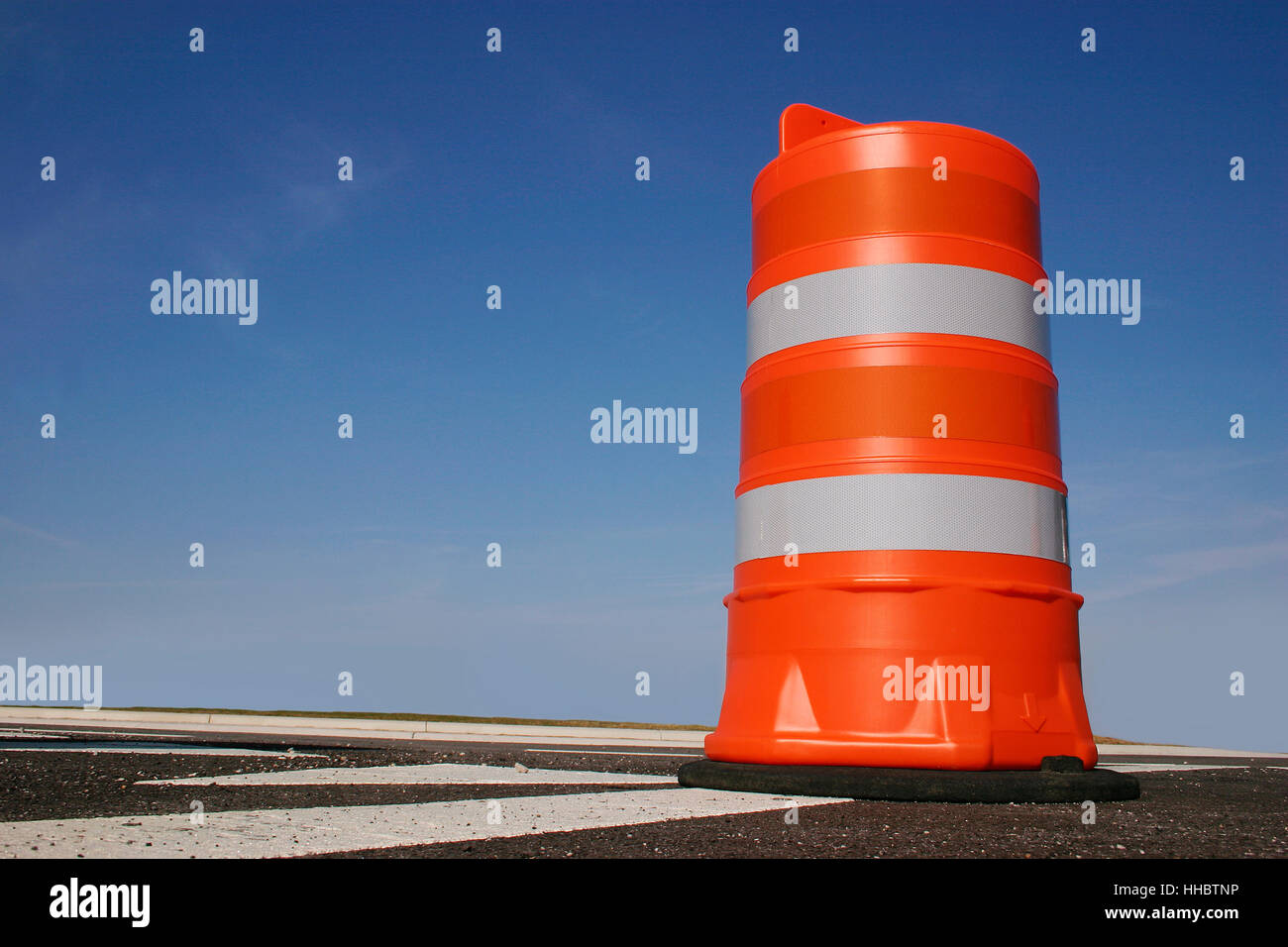 One orange construction barrel signaling roadwork ahead Stock Photo - Alamy