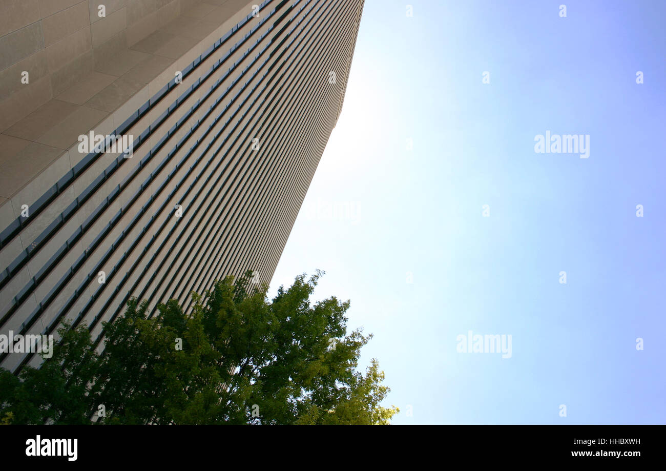 A towering office building looming at an extreme angle. Looking up at ...