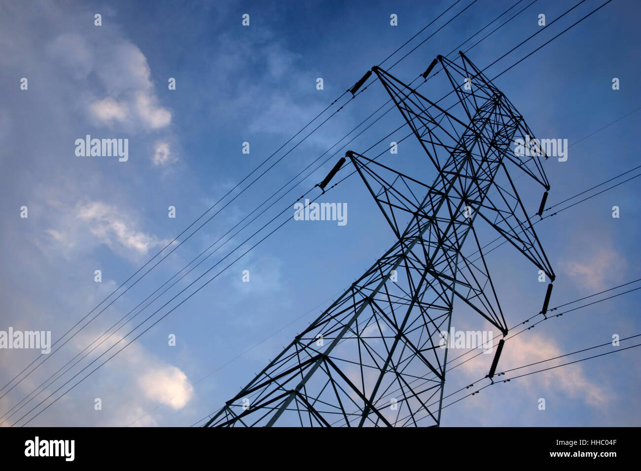 Silhouettes of power lines and a tower with a deep blue sky Stock Photo ...