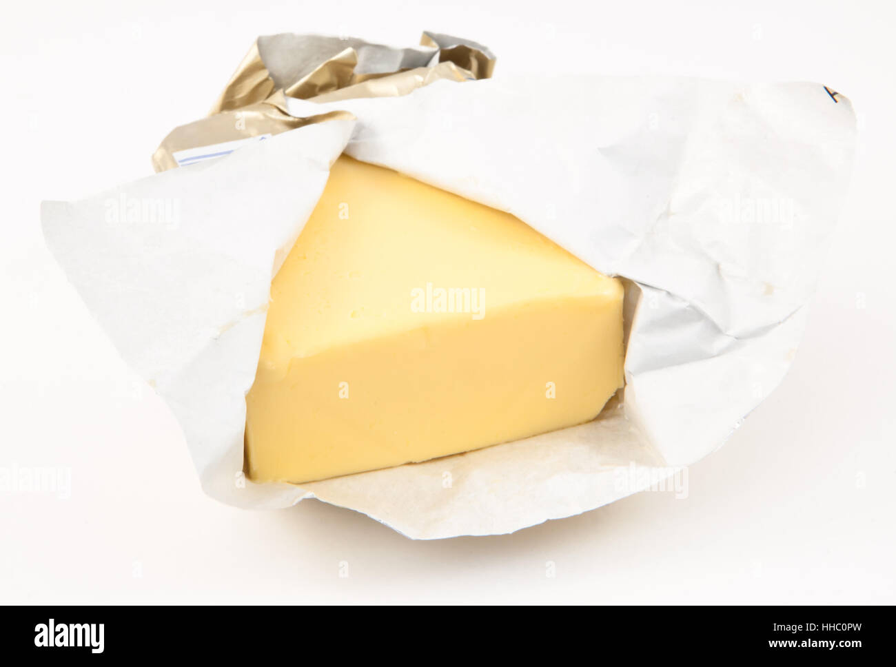 Open pat of butter against white background Stock Photo - Alamy