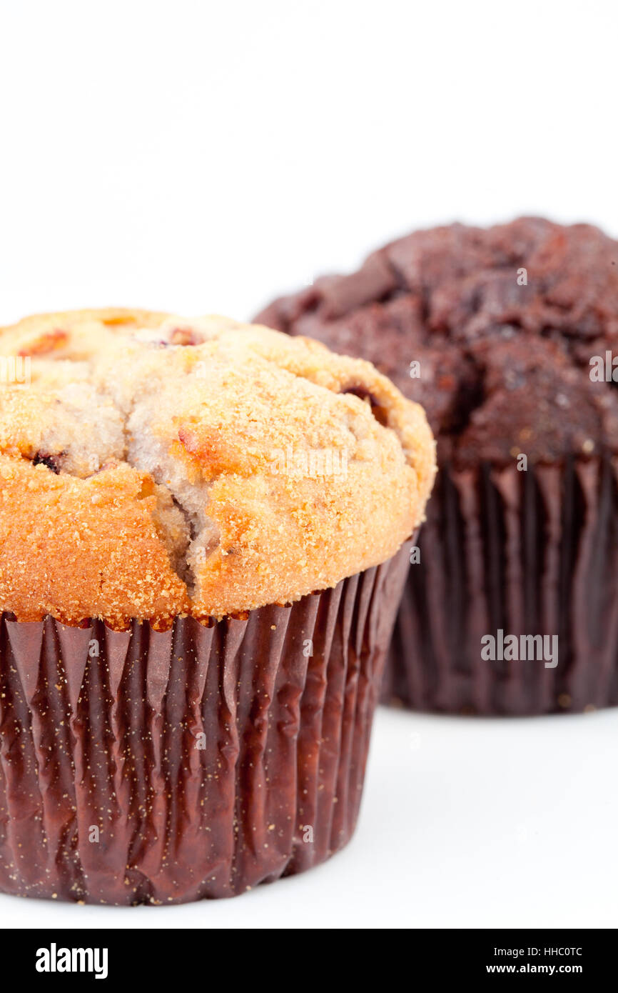 Close up of two fresh baked muffin and a blurred chocolate muffin ...