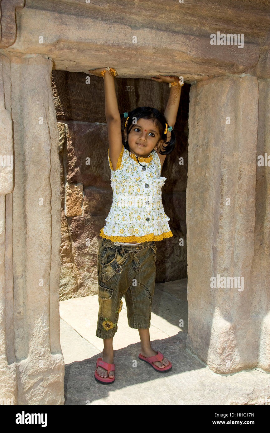 Tiny little girl pretending to lift the upper door slab Stock Photo - Alamy