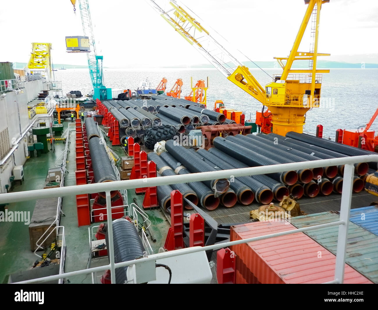 The deck lay barge. Laying pipe with a crane lay barge Stock Photo - Alamy