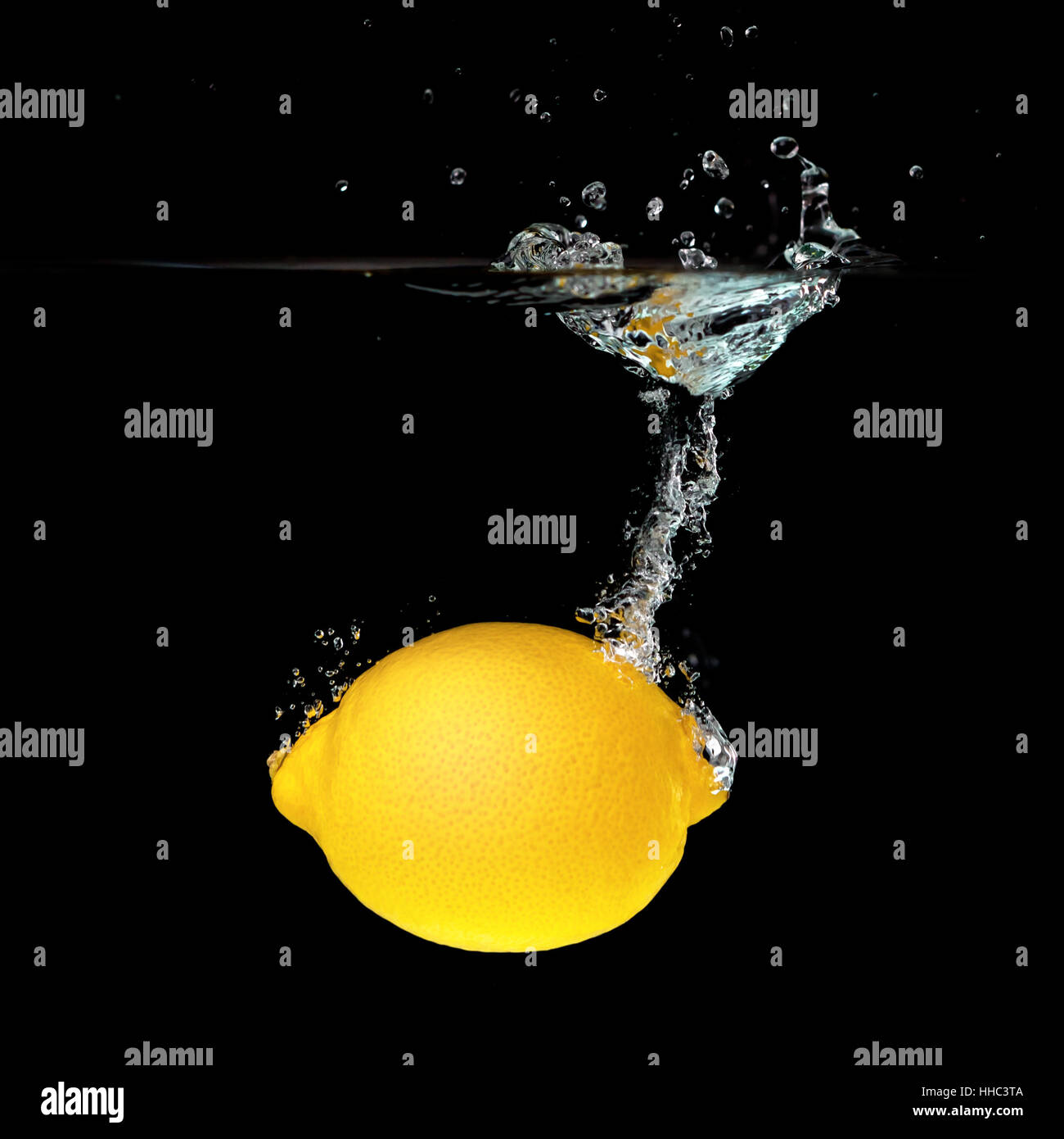 Fresh lemon falling into water isolated on black background Stock Photo ...