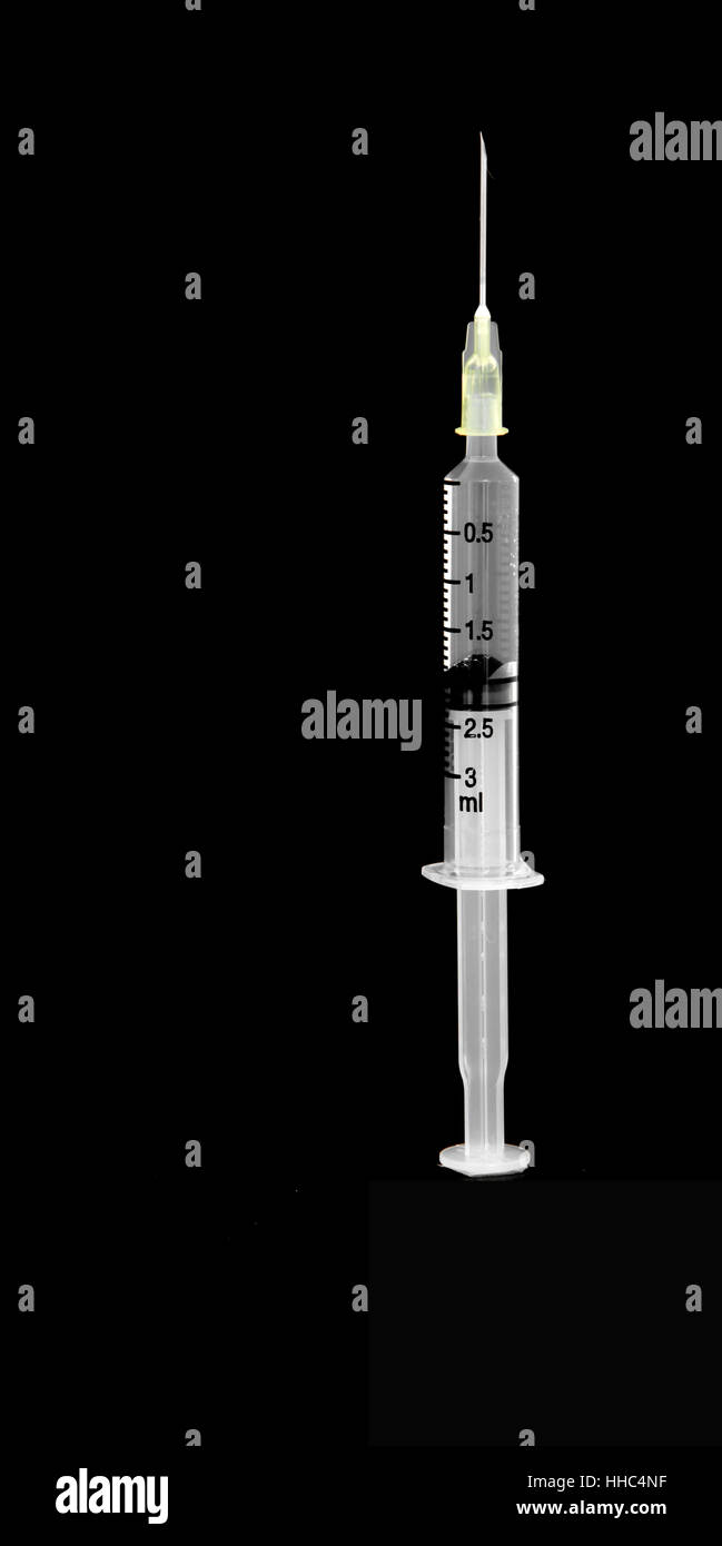 Plastic syringe with clear water inside isolated on black background ...