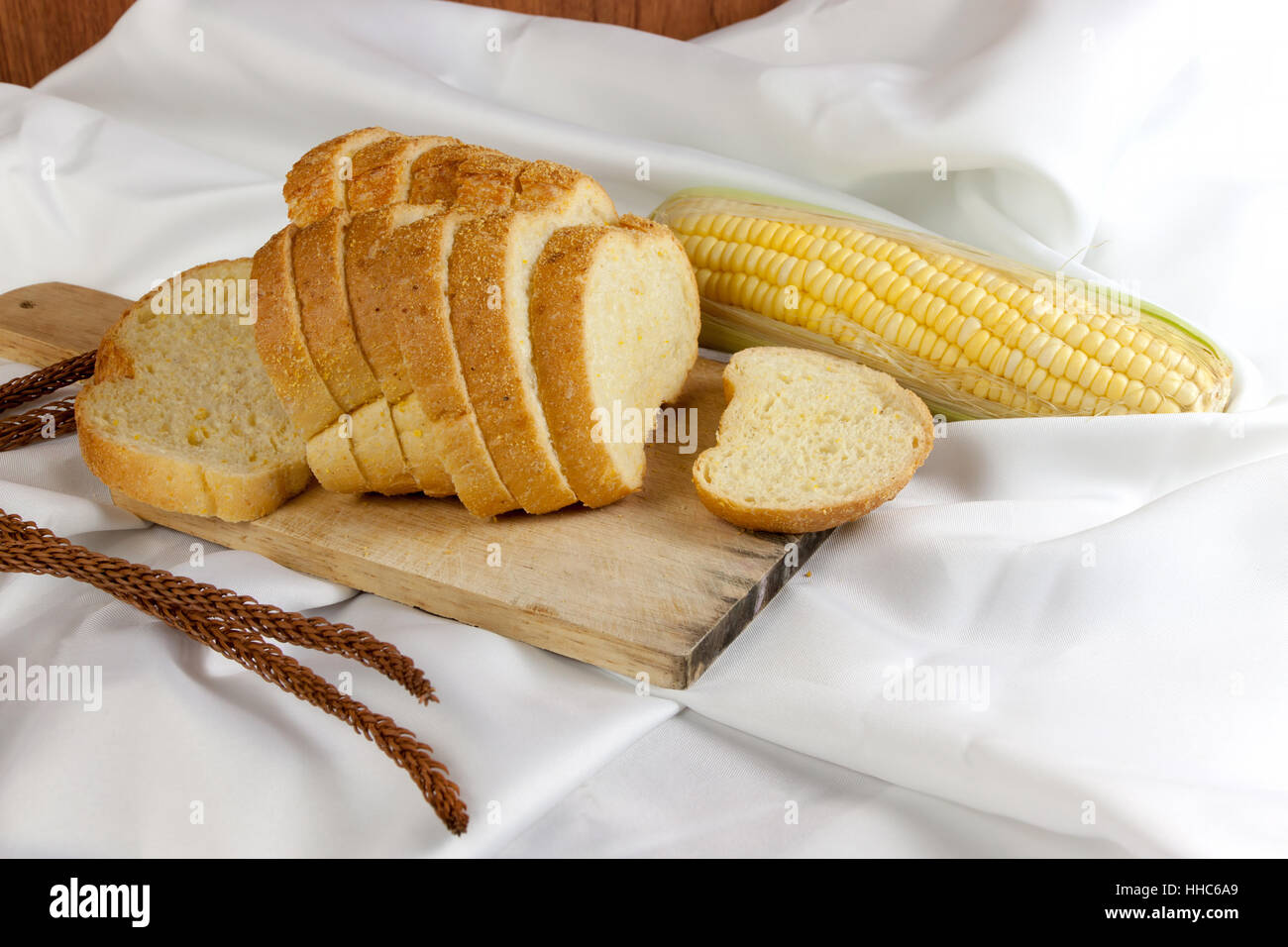 bread made from corn on the white fabric. Slices of corn bread laying ...