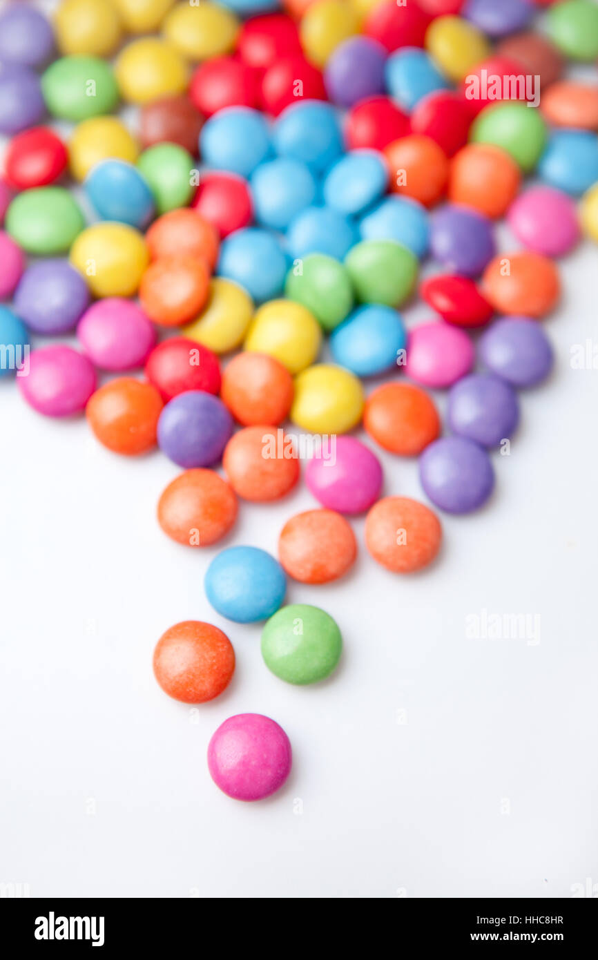 Multicolored chocolate candies against a white background Stock Photo ...