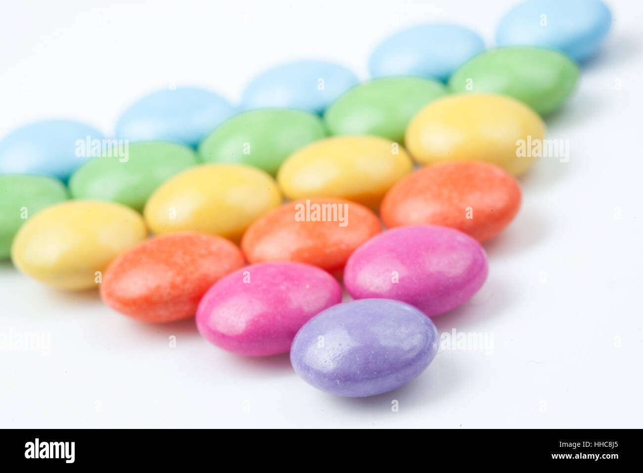 Triangle of candies against a white background Stock Photo - Alamy