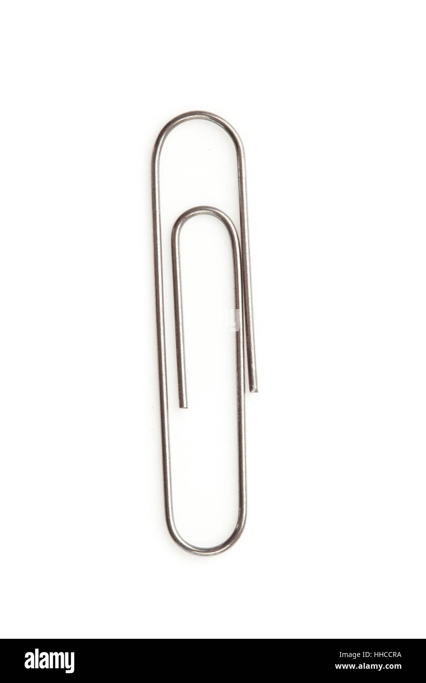 Close up of a grey paperclip on the floor against a white background ...