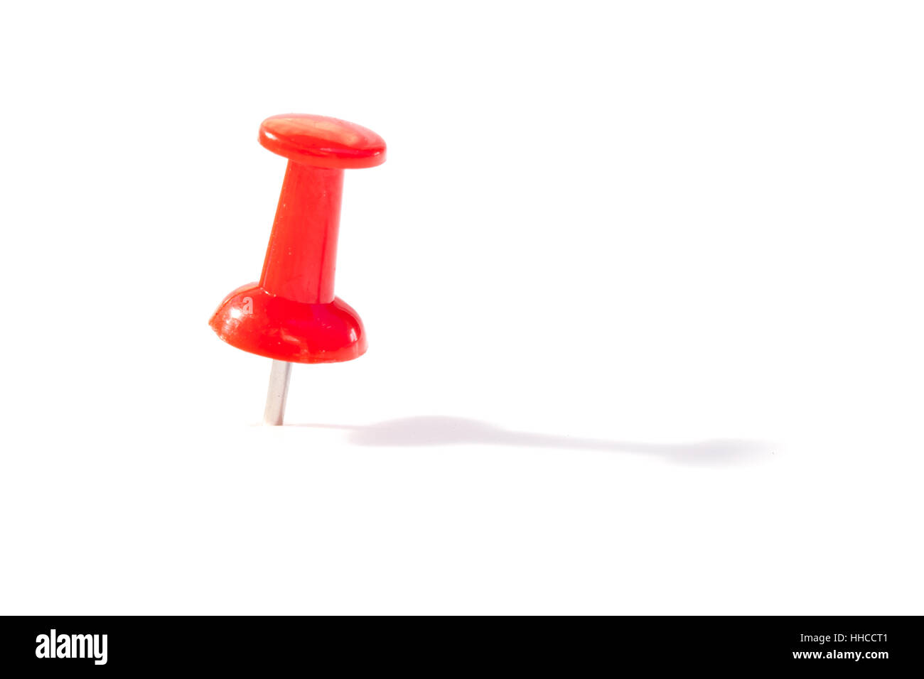Vertical push pin against a white background Stock Photo - Alamy