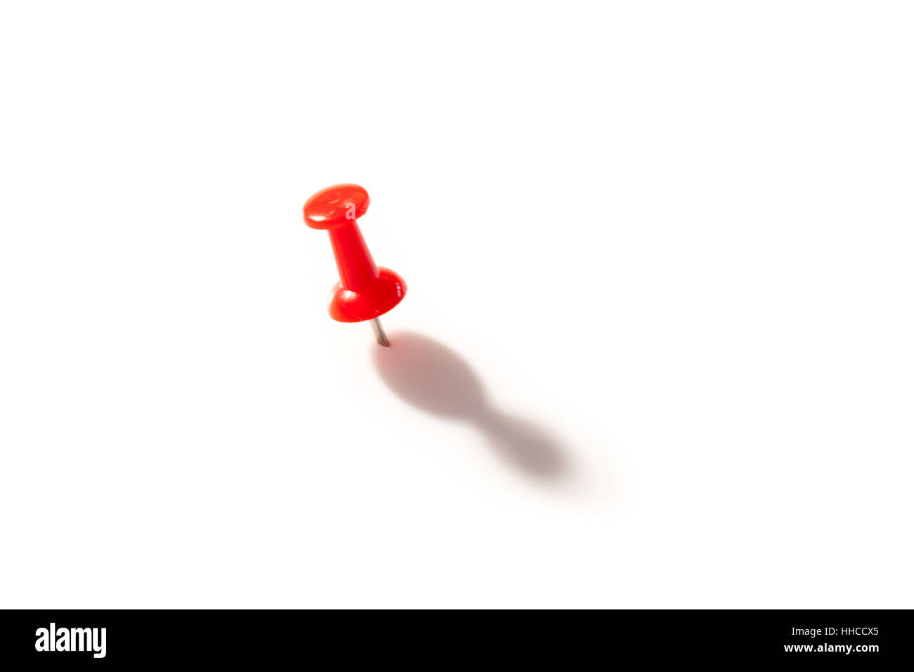 Red pushpin against a white background Stock Photo - Alamy