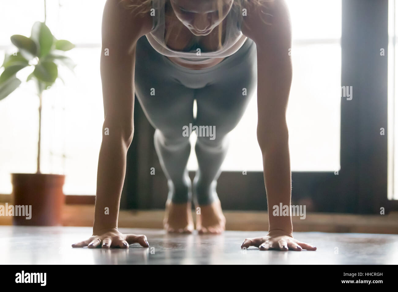 Young attractive woman in Plank pose, home interior background Stock ...
