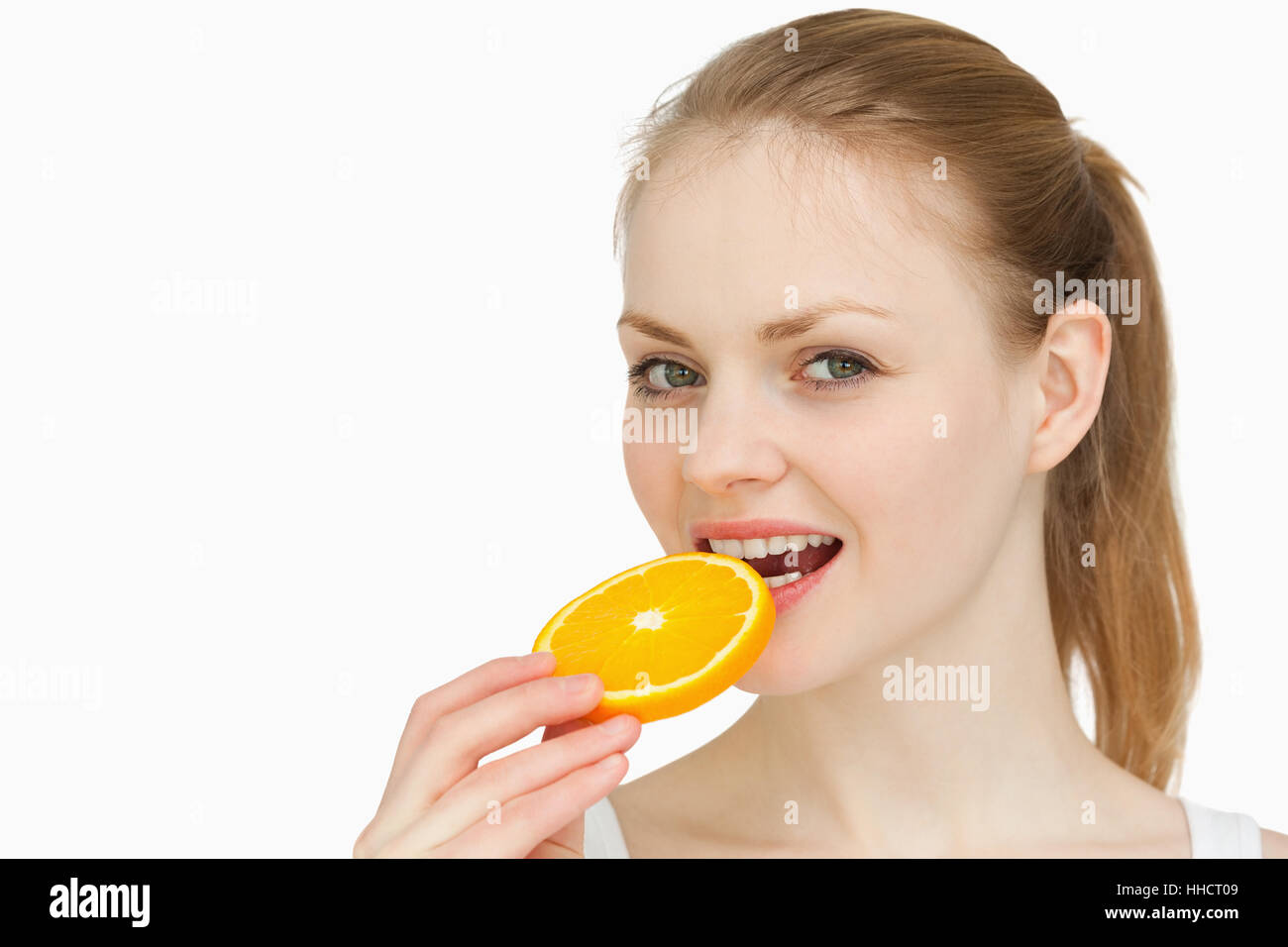 Orange slice in her mouth hi-res stock photography and images - Alamy