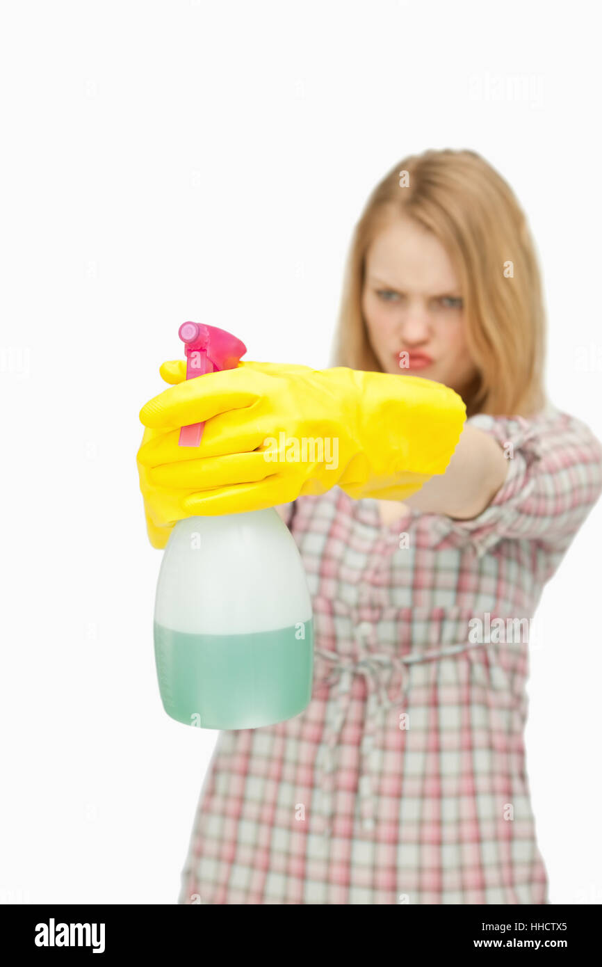 Young woman holding a spray bottle against white background Stock Photo ...