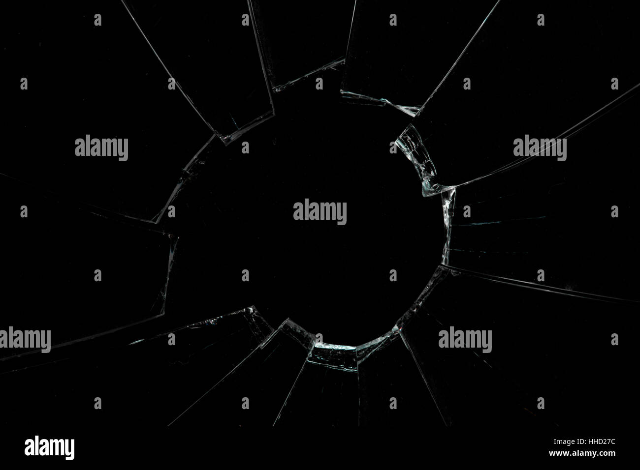 Crackled and broken window against a black background Stock Photo - Alamy