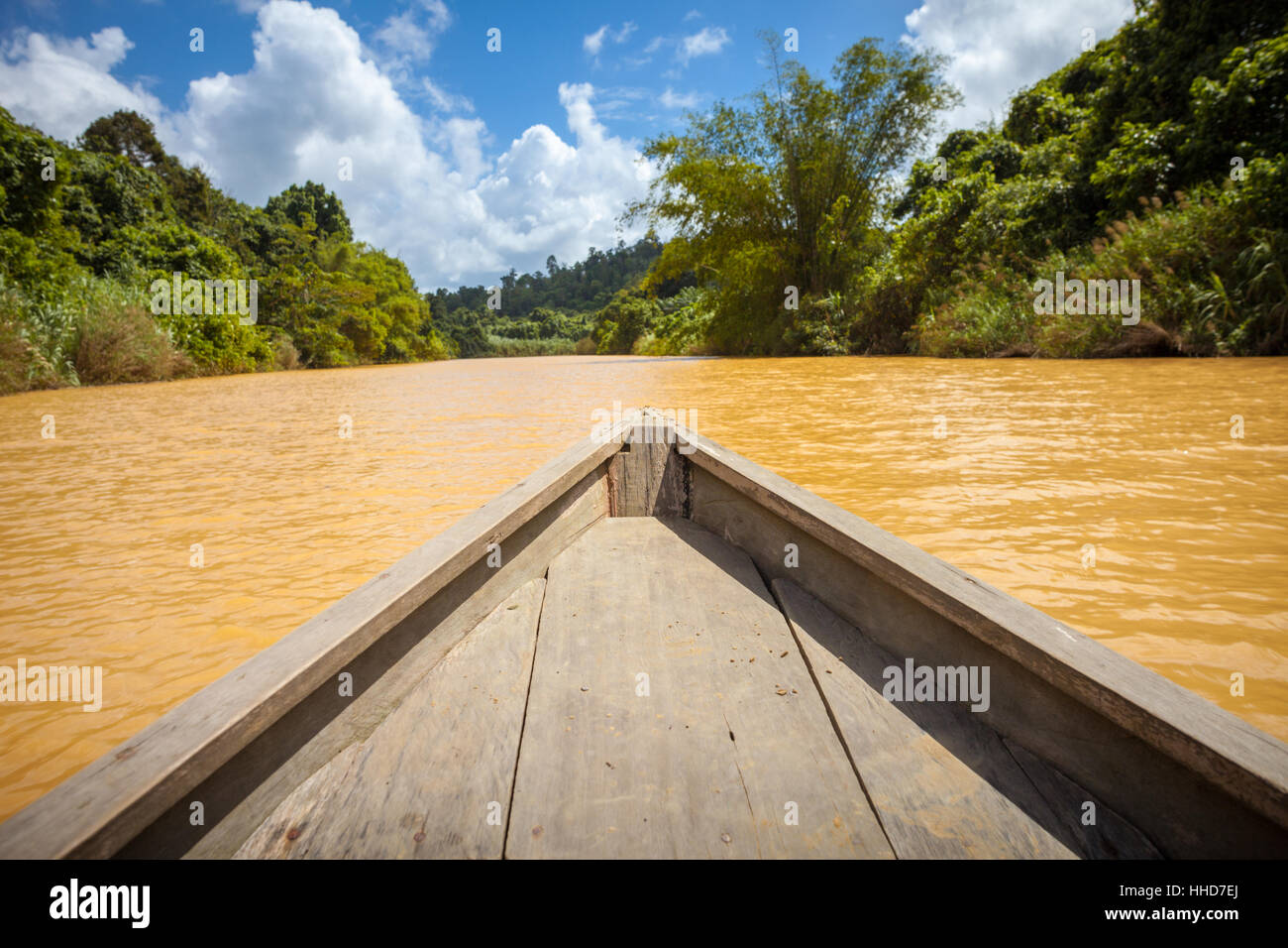Boat in a river, near Paitan, Sabah, Malaysian Borneo. Water is stained ...