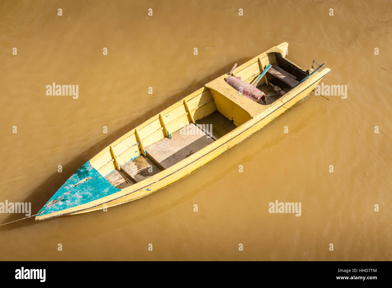 Boat in a river, near Paitan, Sabah, Malaysian Borneo. Water is stained ...