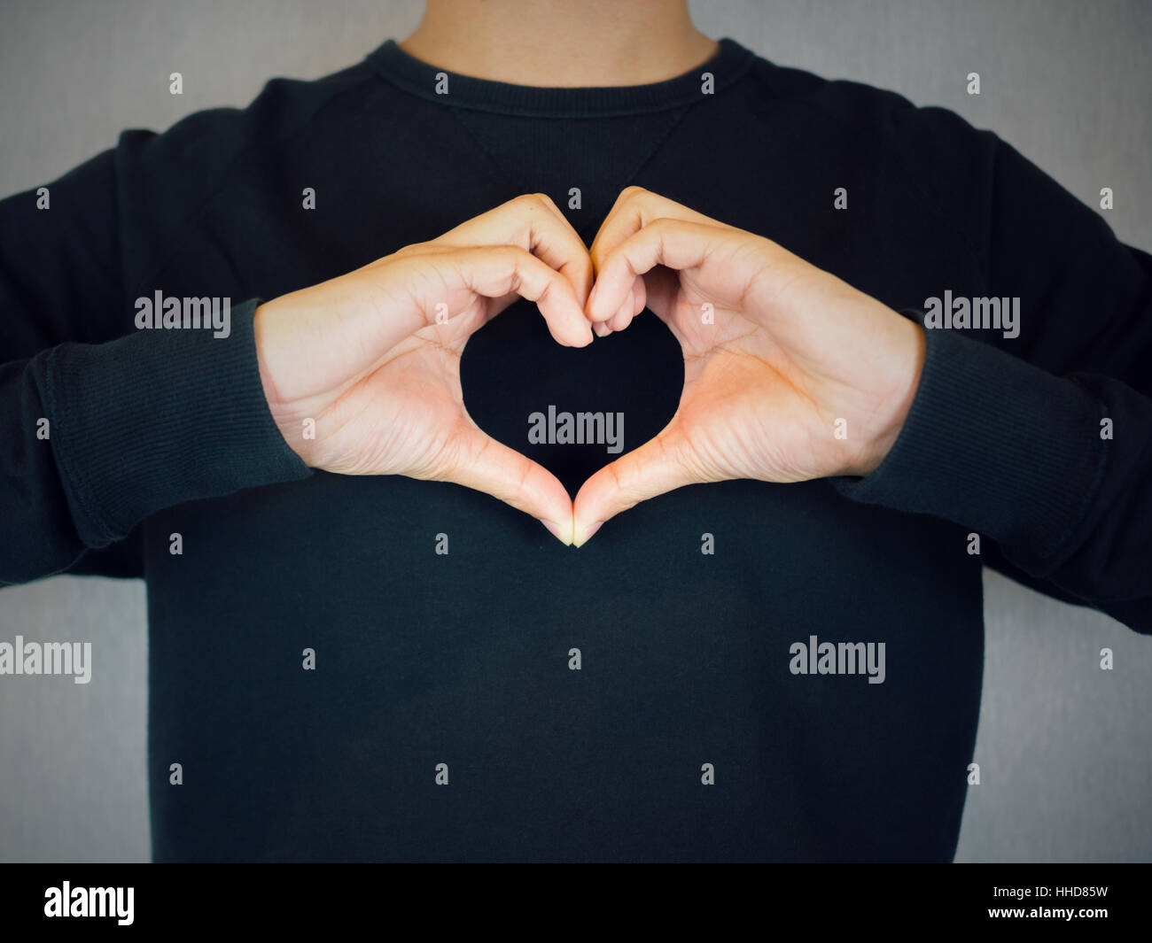 Man making heart shape gesture by hands Stock Photo - Alamy