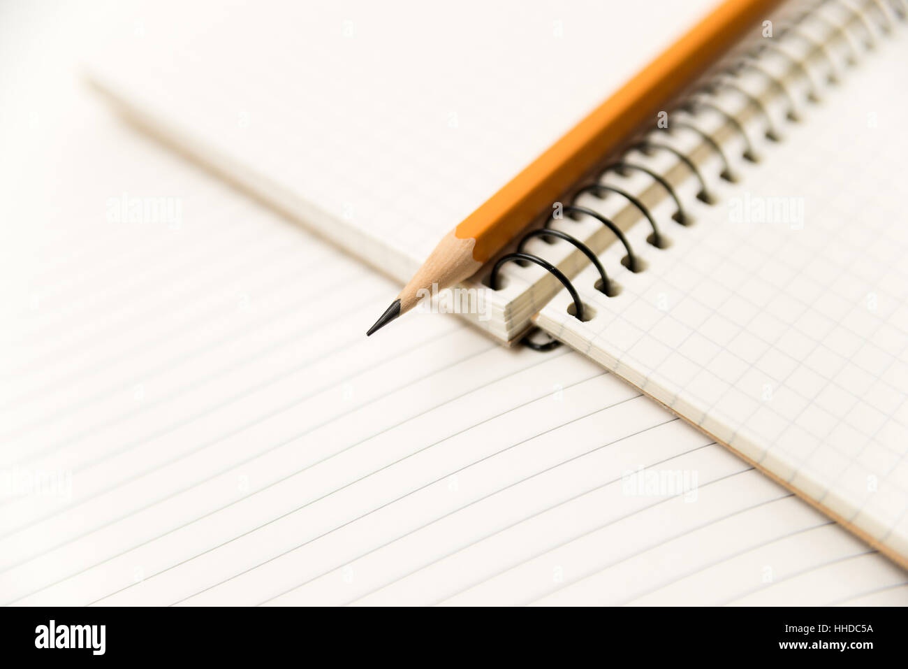 Pencil on the pages of an open notebook Stock Photo - Alamy