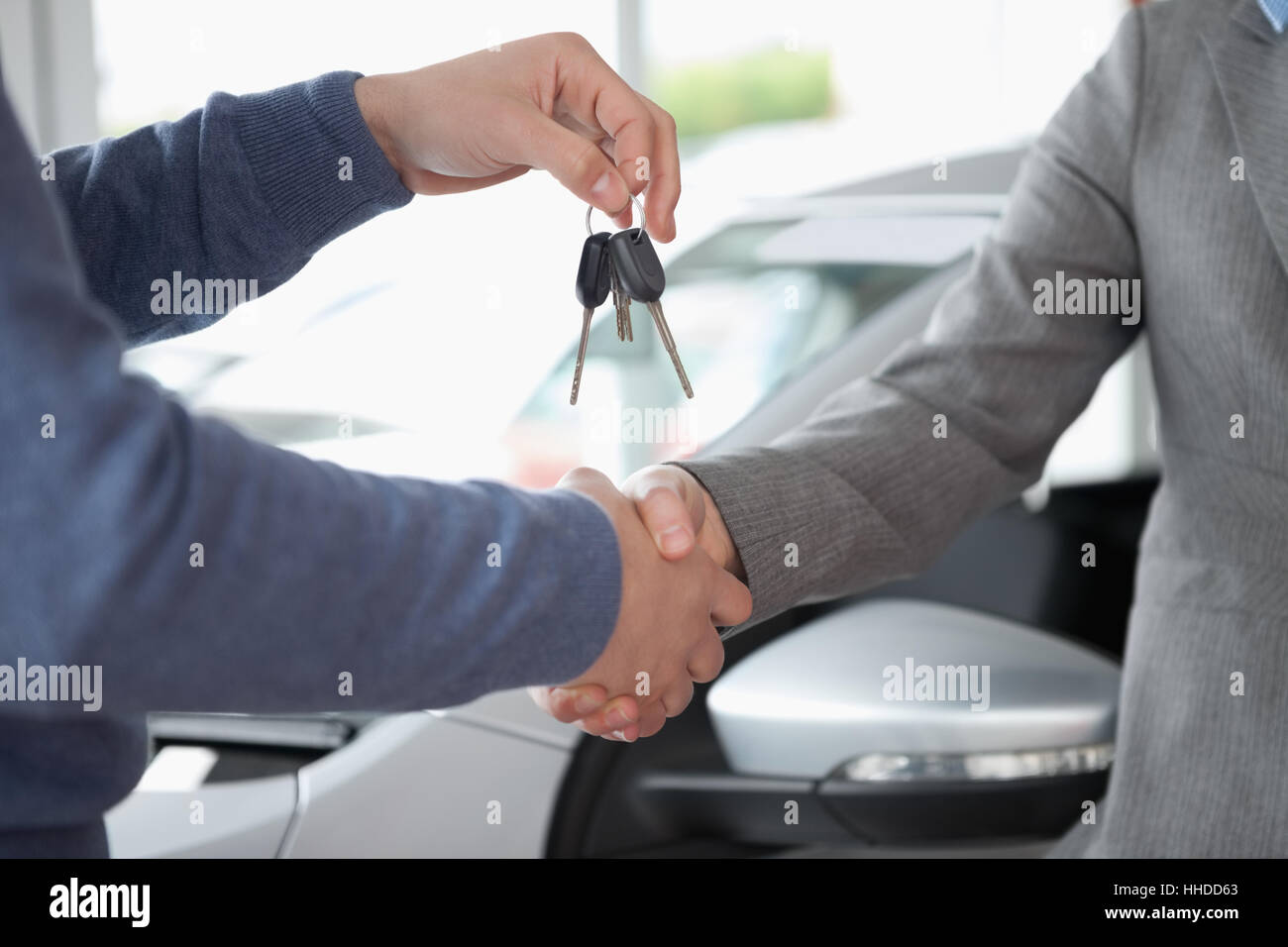 People shaking each other hands while holding keys Stock Photo - Alamy