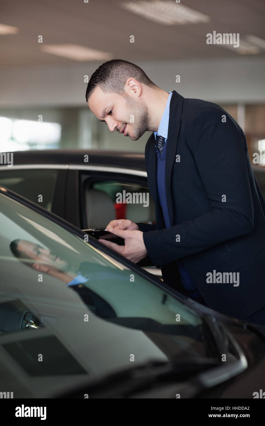 Professional car salesman holding clipboard hi-res stock photography ...