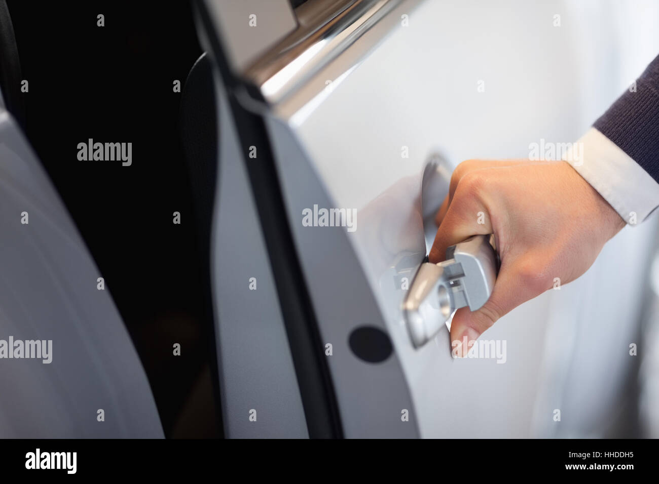 Man opening a car door in a garage Stock Photo - Alamy