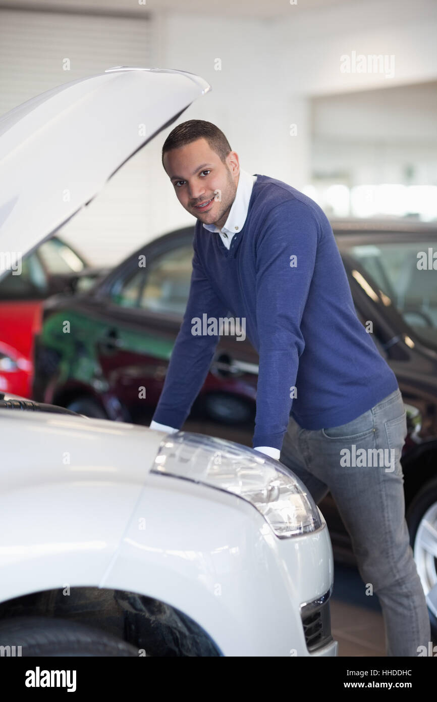 Man leaning above a car in a garage Stock Photo - Alamy
