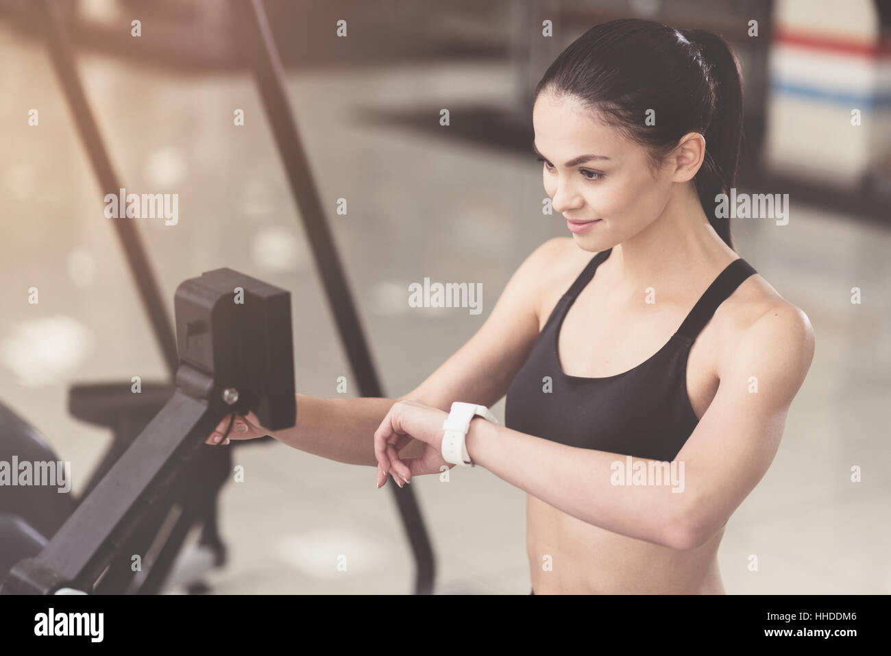 Active woman using smart watch in a gym Stock Photo - Alamy
