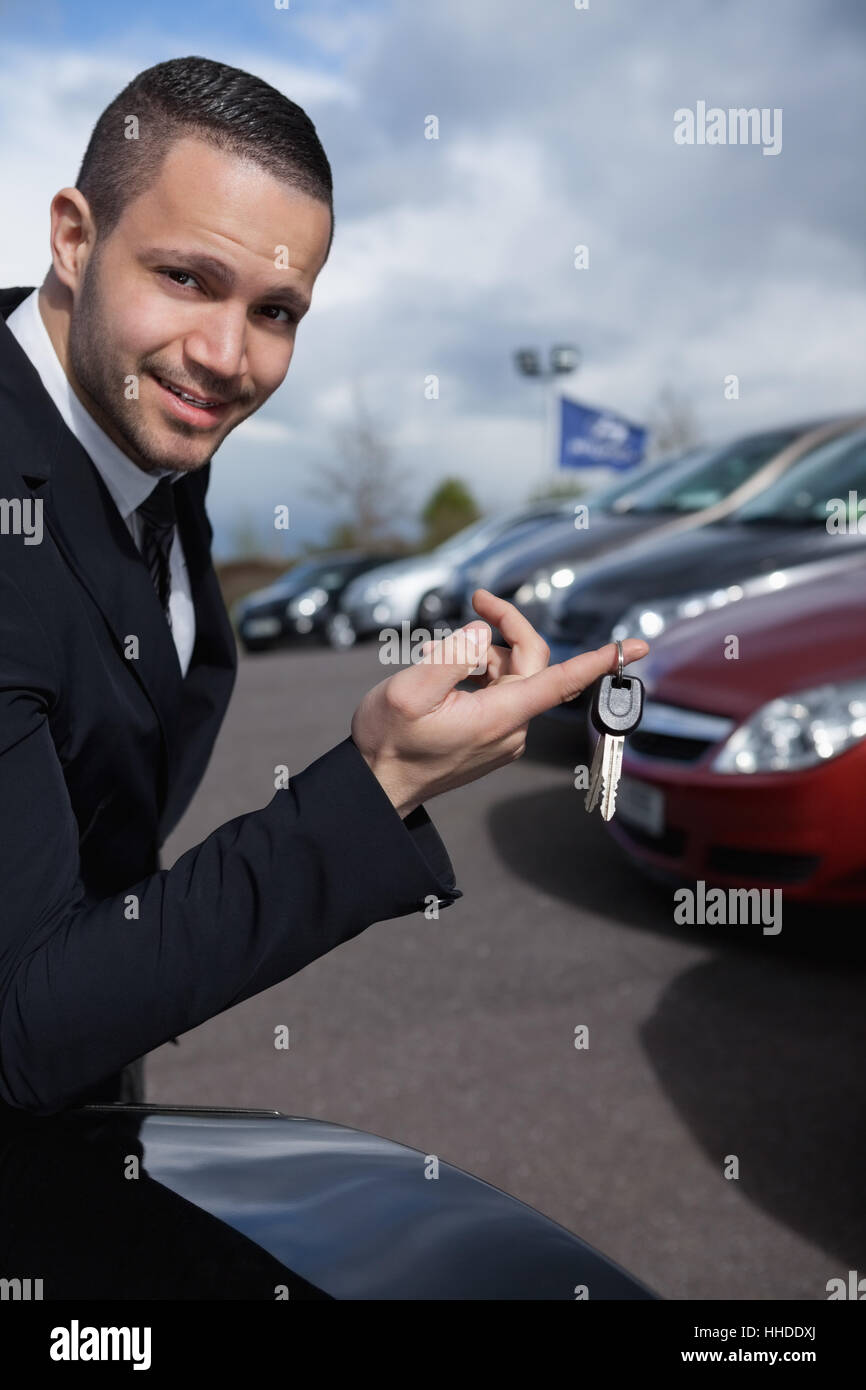 Man holding car keys with a finger outdoors Stock Photo - Alamy