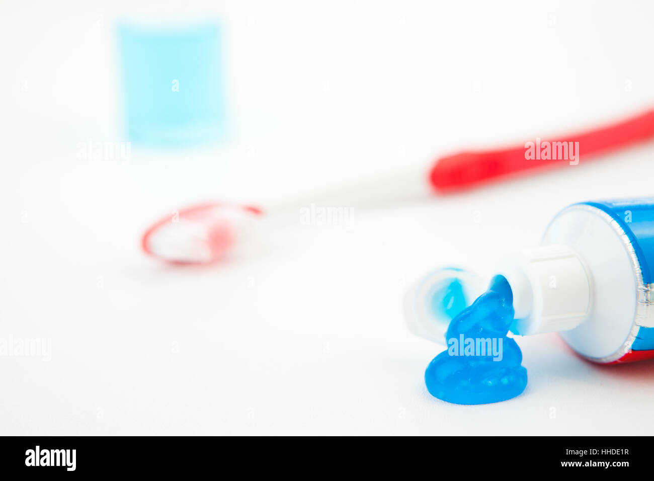 Blue toothpaste outgoing of the tube of toothpaste against white ...