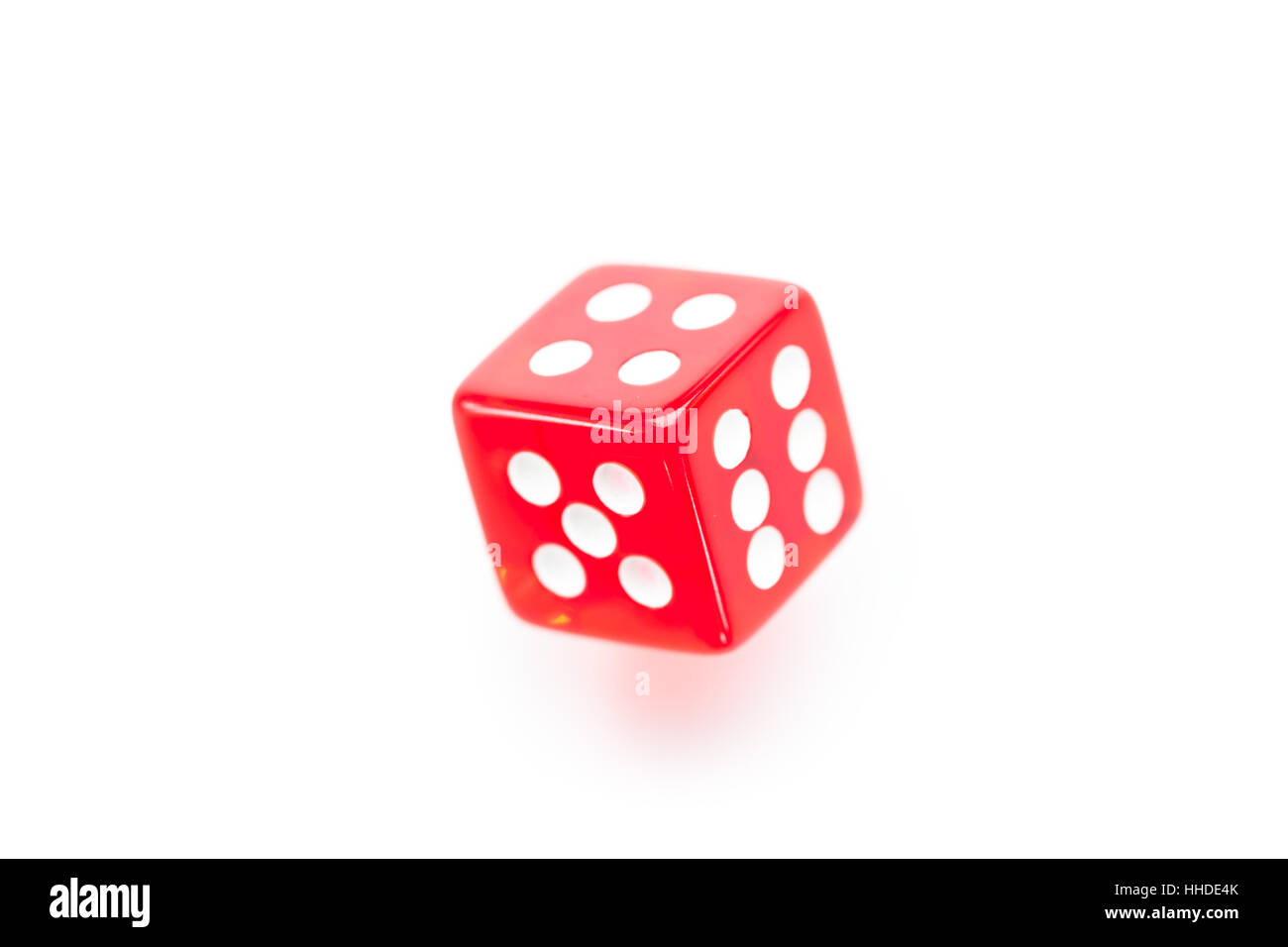 Red dice moving against a white background Stock Photo - Alamy