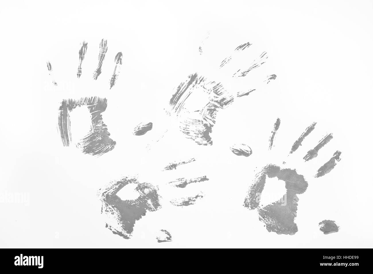 Four grey handprints against a white background Stock Photo - Alamy