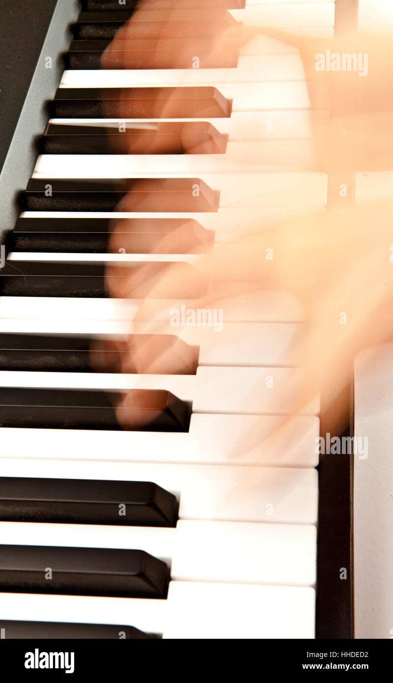 Hands playing piano in motion Stock Photo - Alamy