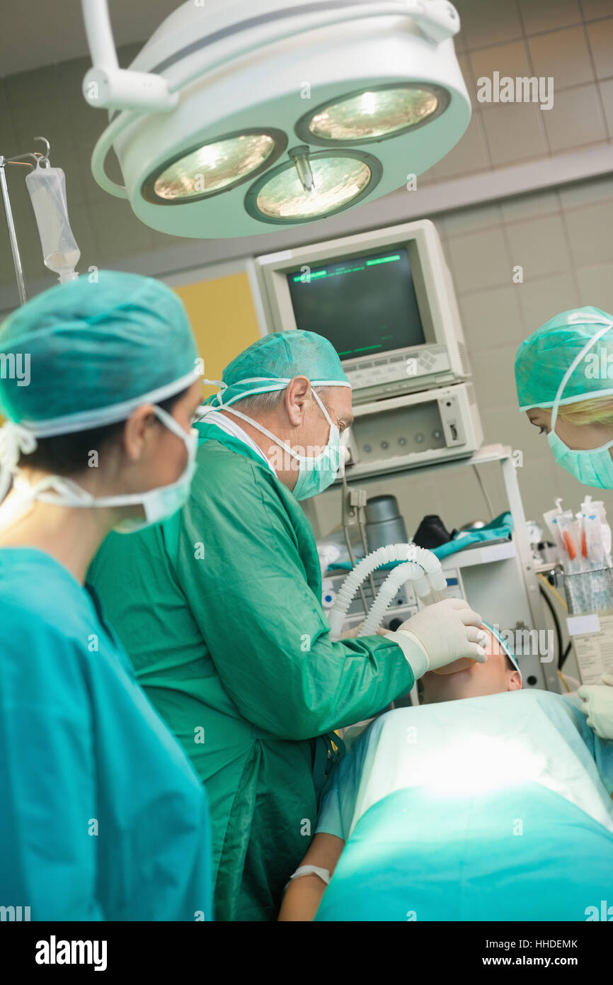 Medical team operating in a surgical room Stock Photo - Alamy