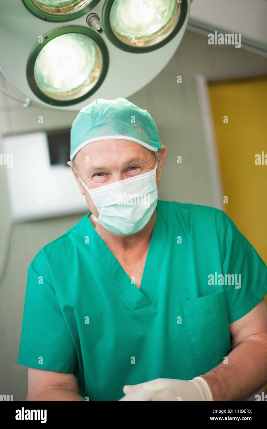 Surgeon smiles as he stands in a surgical room Stock Photo - Alamy