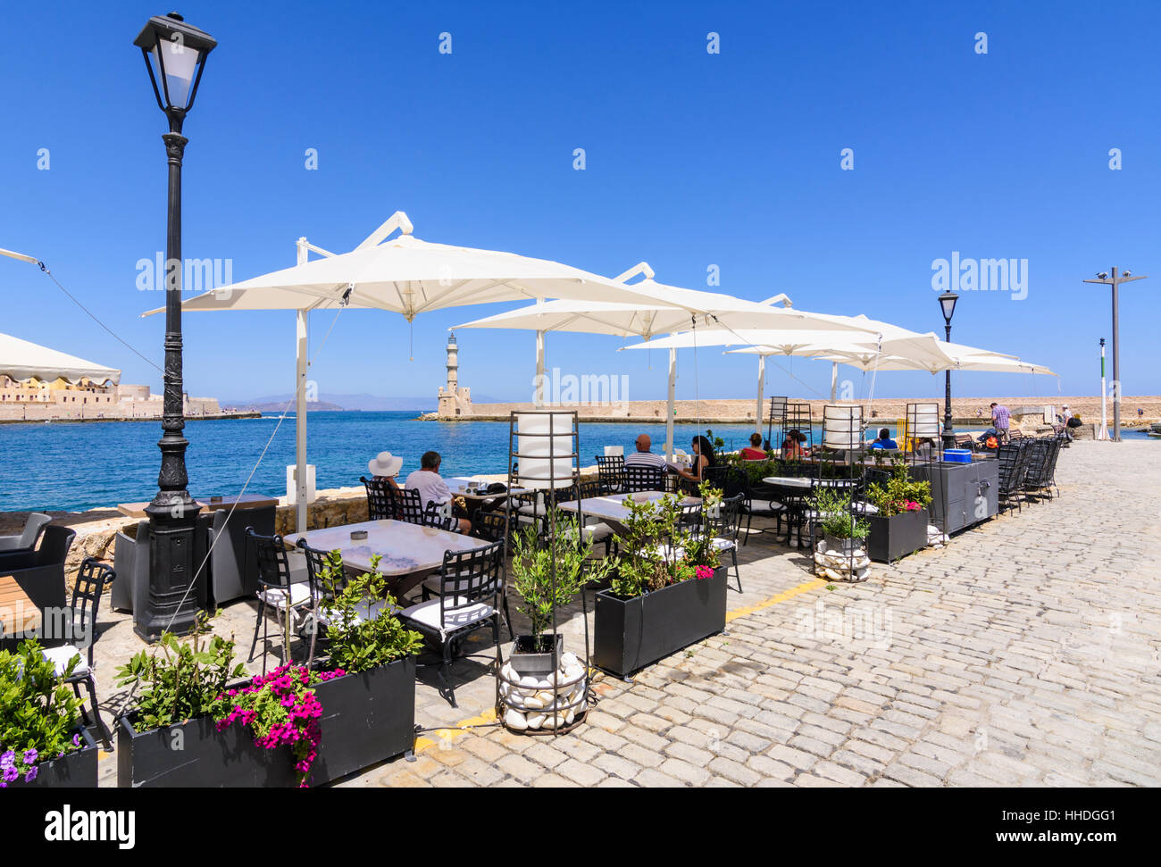 Waterfront promenade restaurant on the old Venetian harbour of Chania ...