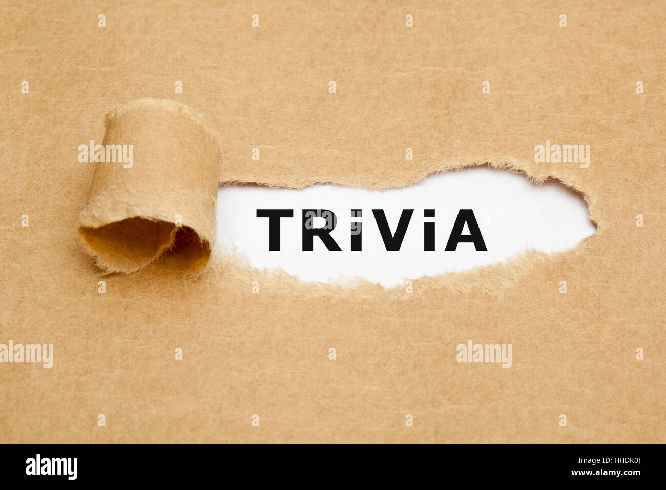 The word Trivia appearing behind torn brown paper Stock Photo - Alamy