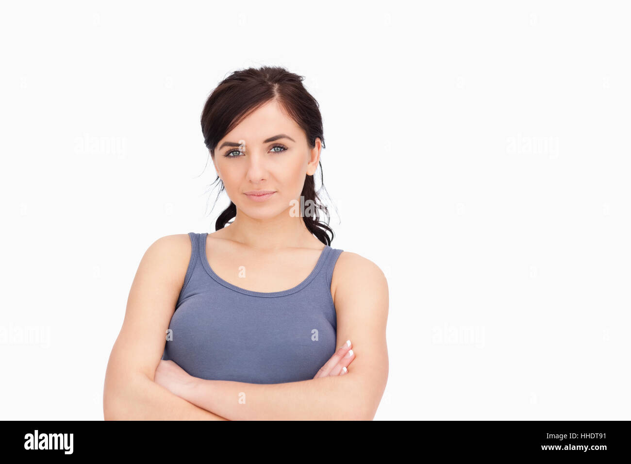Brunette with folded arms against white background Stock Photo - Alamy