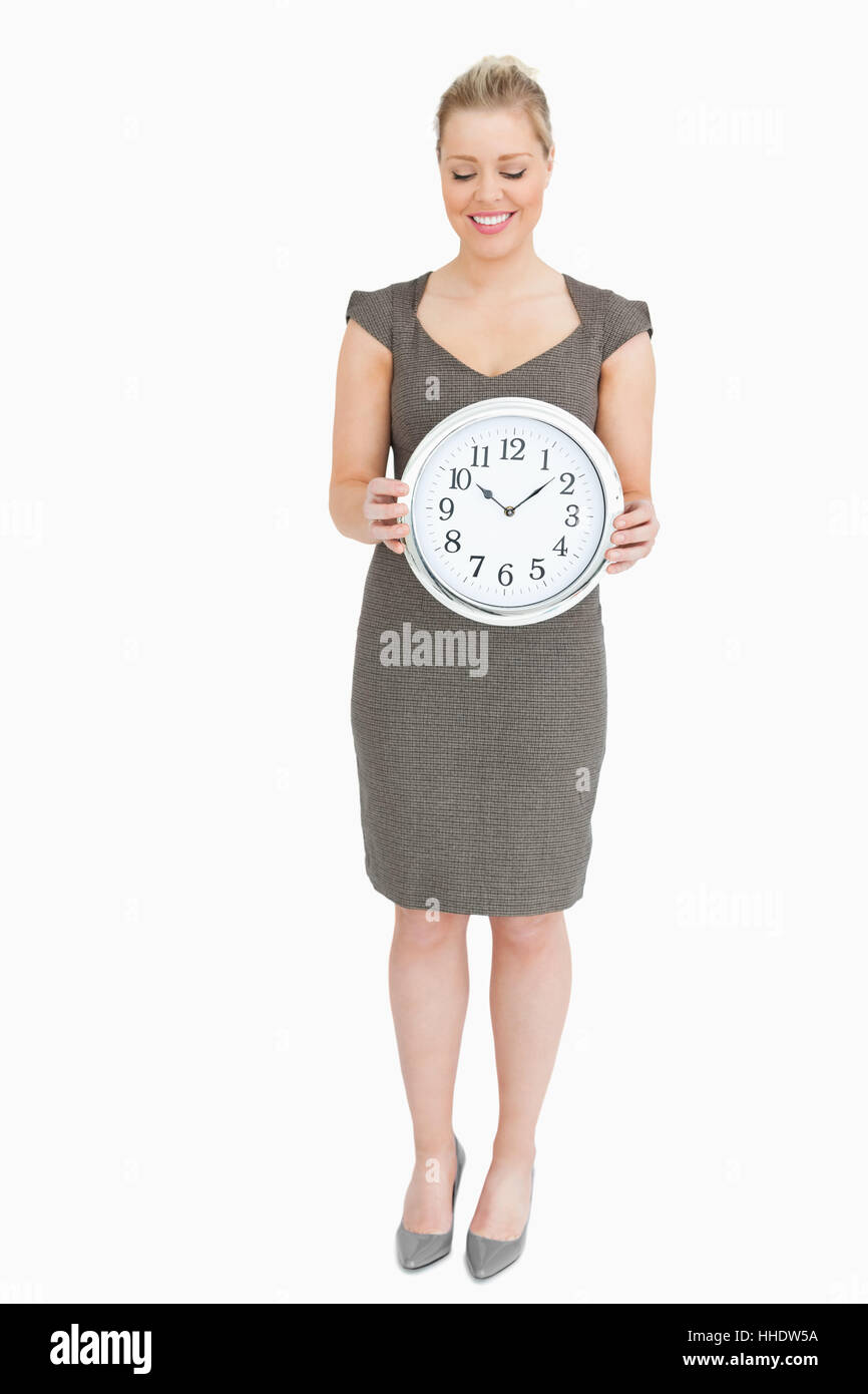 Woman showing a clock against white background Stock Photo - Alamy