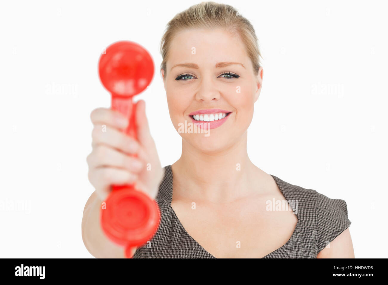 Retro phone red in a hand of a pretty woman against white background ...