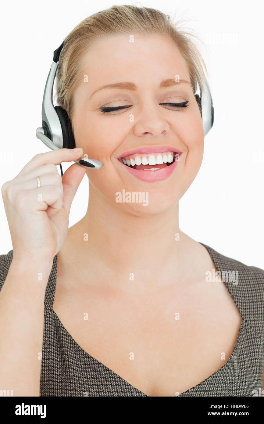 Woman speaking with her headset against white background Stock Photo - Alamy